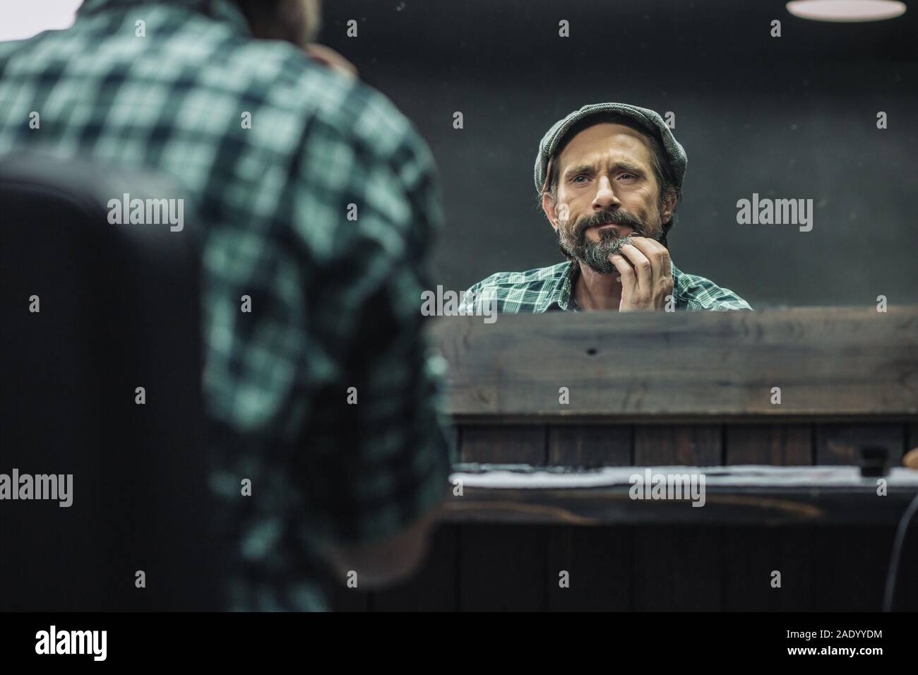 Middle aged man frowning while touching his beard Stock Photo - Alamy Middle aged man frowning while touching his beard Stock Photo - Alamy