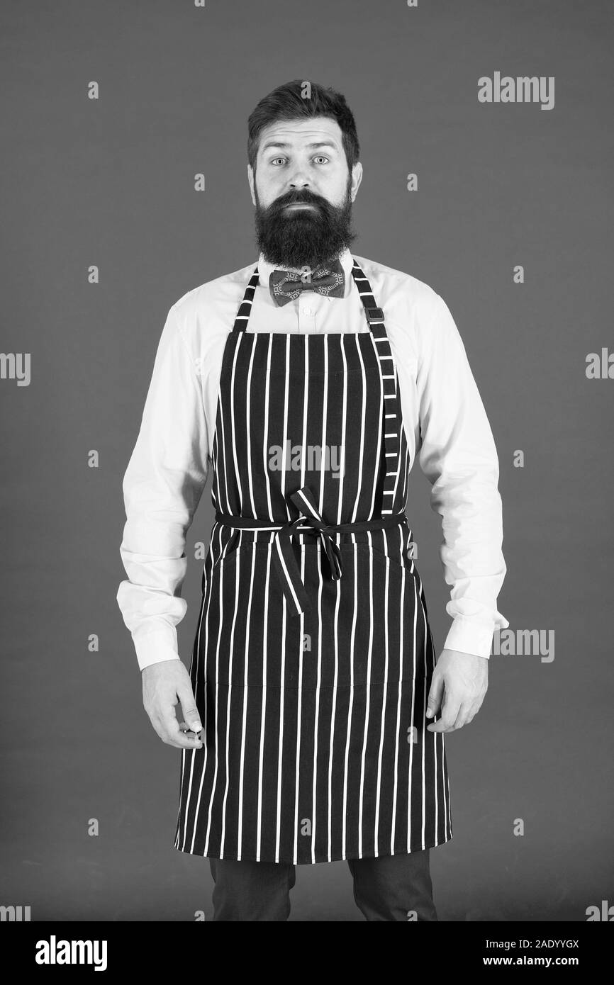 I am entirely at your service. A man servant. Bearded man wearing bib ...