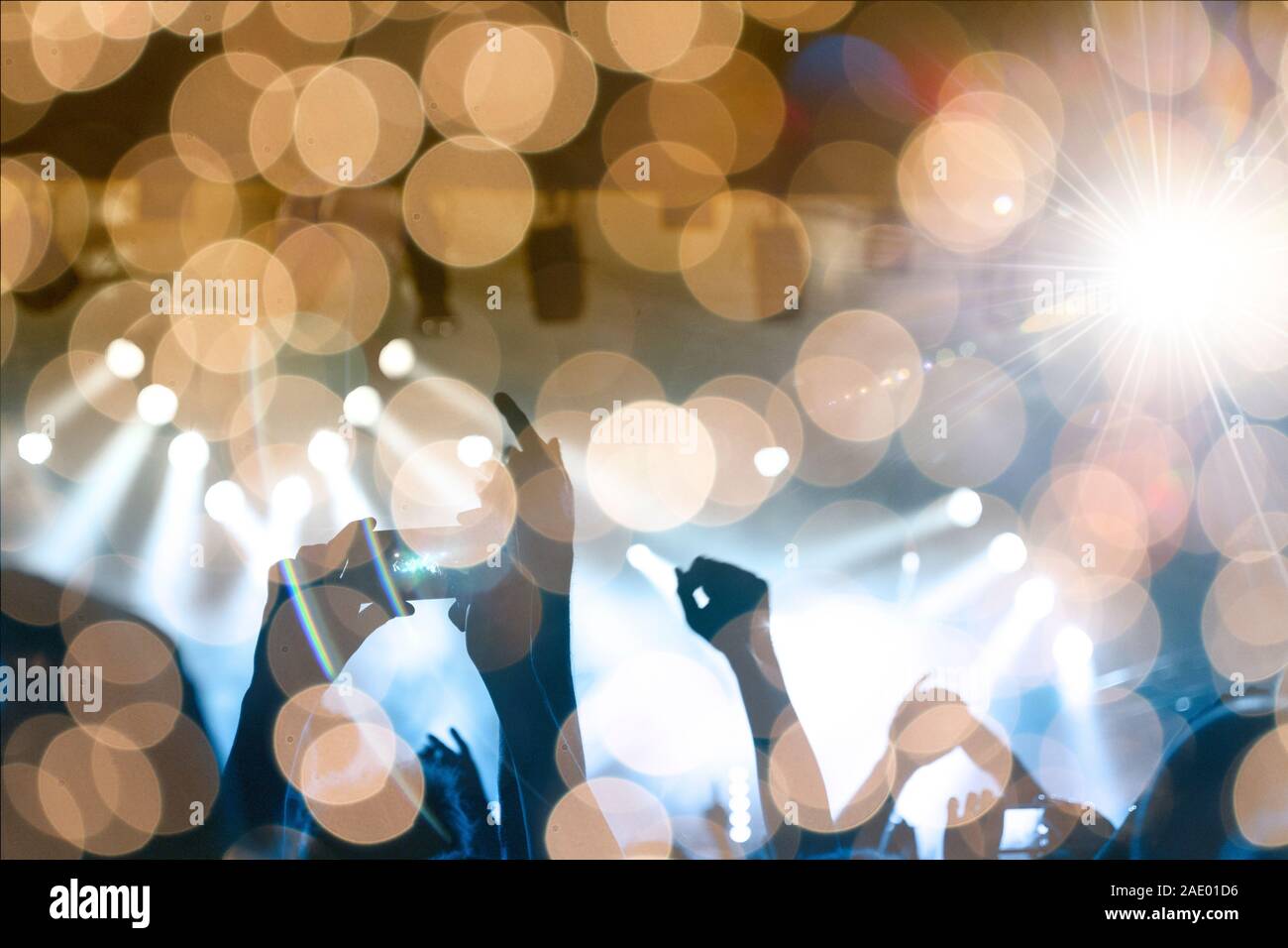 Photo of a concert hall with people silhouettes clapping in front of a ...