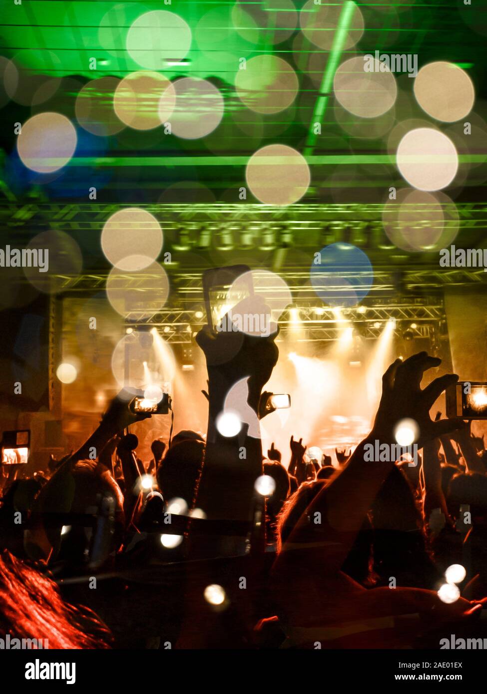 Photo of a concert hall with people silhouettes clapping in front of a ...