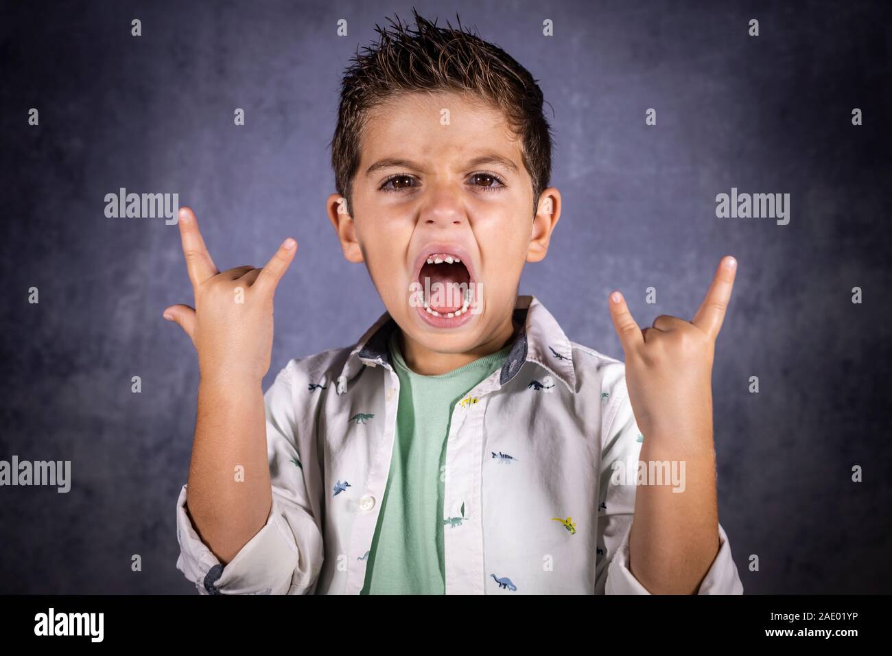 Happy cute child screaming and doing heavy metal rock sign Stock Photo ...