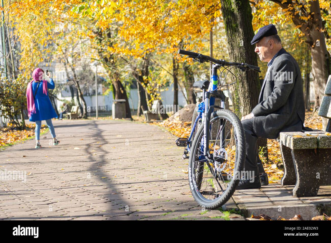 Rasht- IRAN December 4, 2019 a senior man seating in a park bench at ...