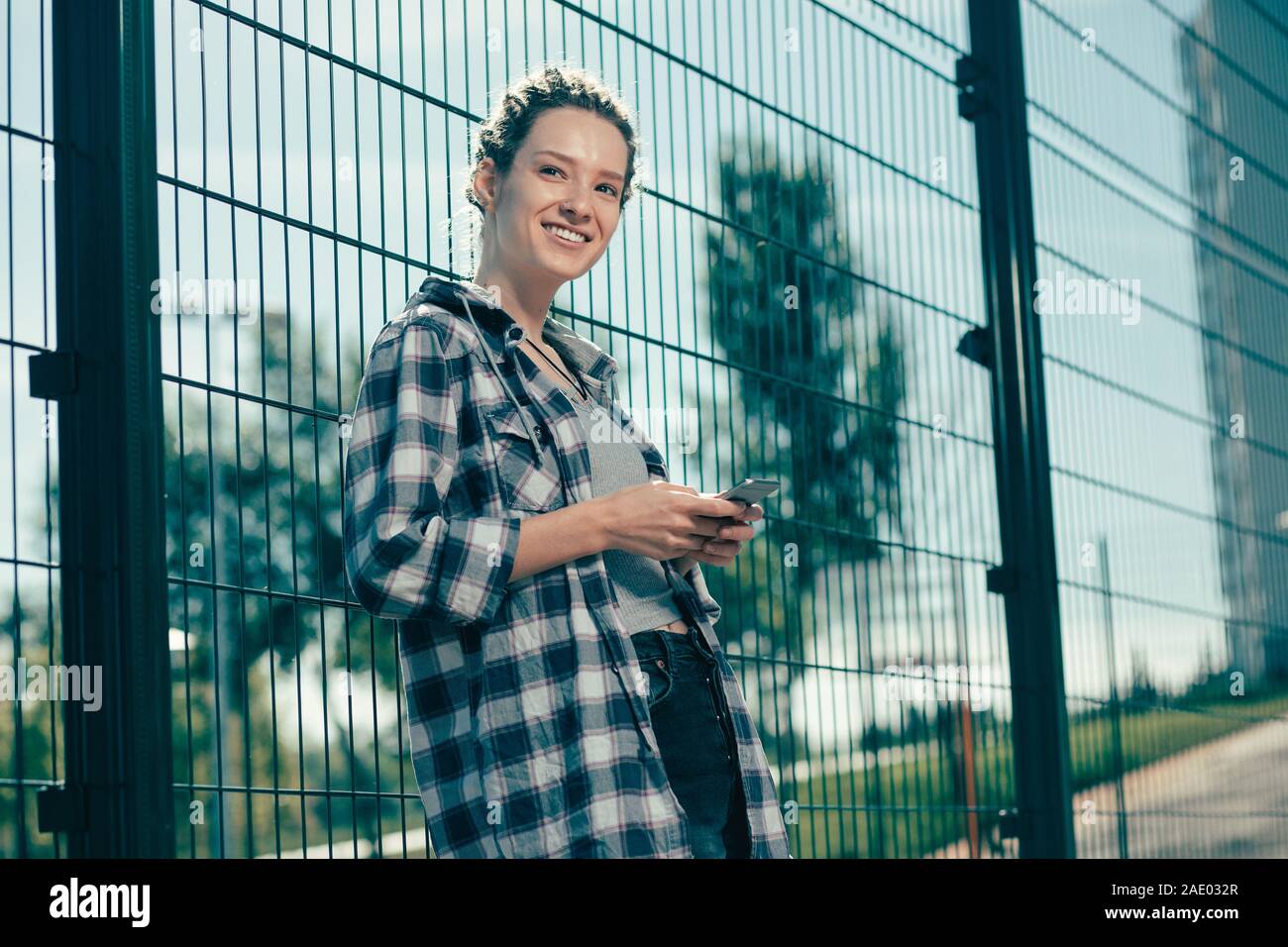 Smiling lady standing alone and looking into the distance Stock Photo ...