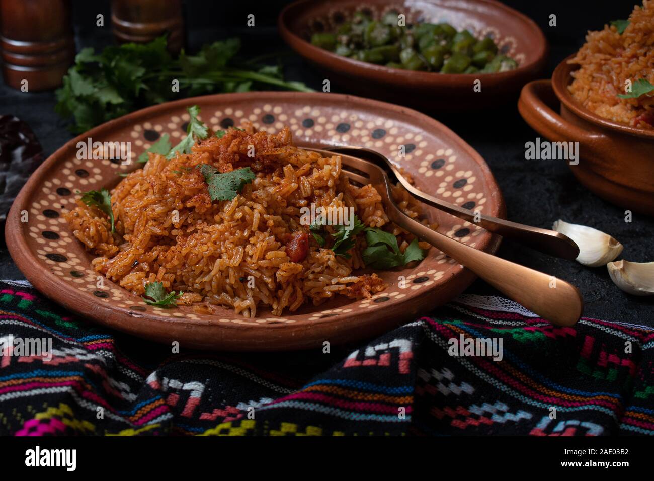 Mexican rice served in traditional clay pot and plate Stock Photo - Alamy