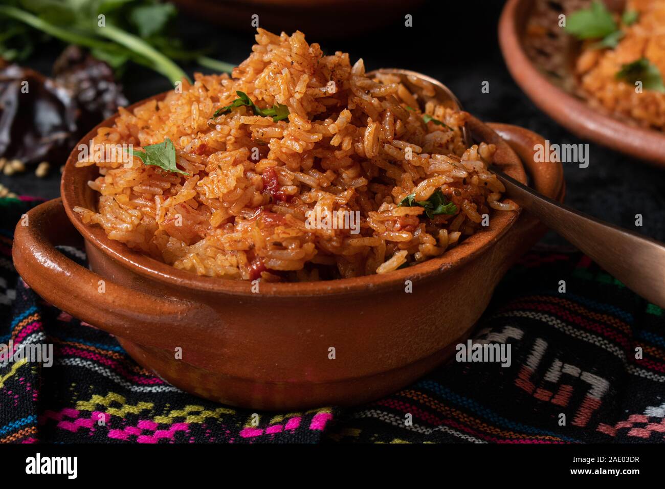 Mexican rice served in traditional clay pot and plate Stock Photo - Alamy