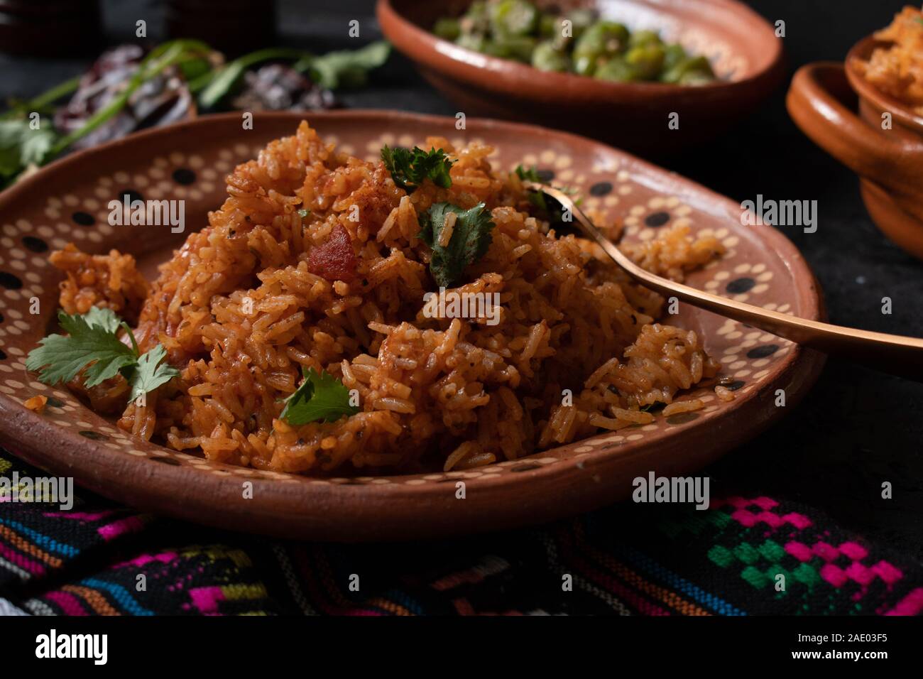Mexican rice served in traditional clay pot and plate Stock Photo - Alamy