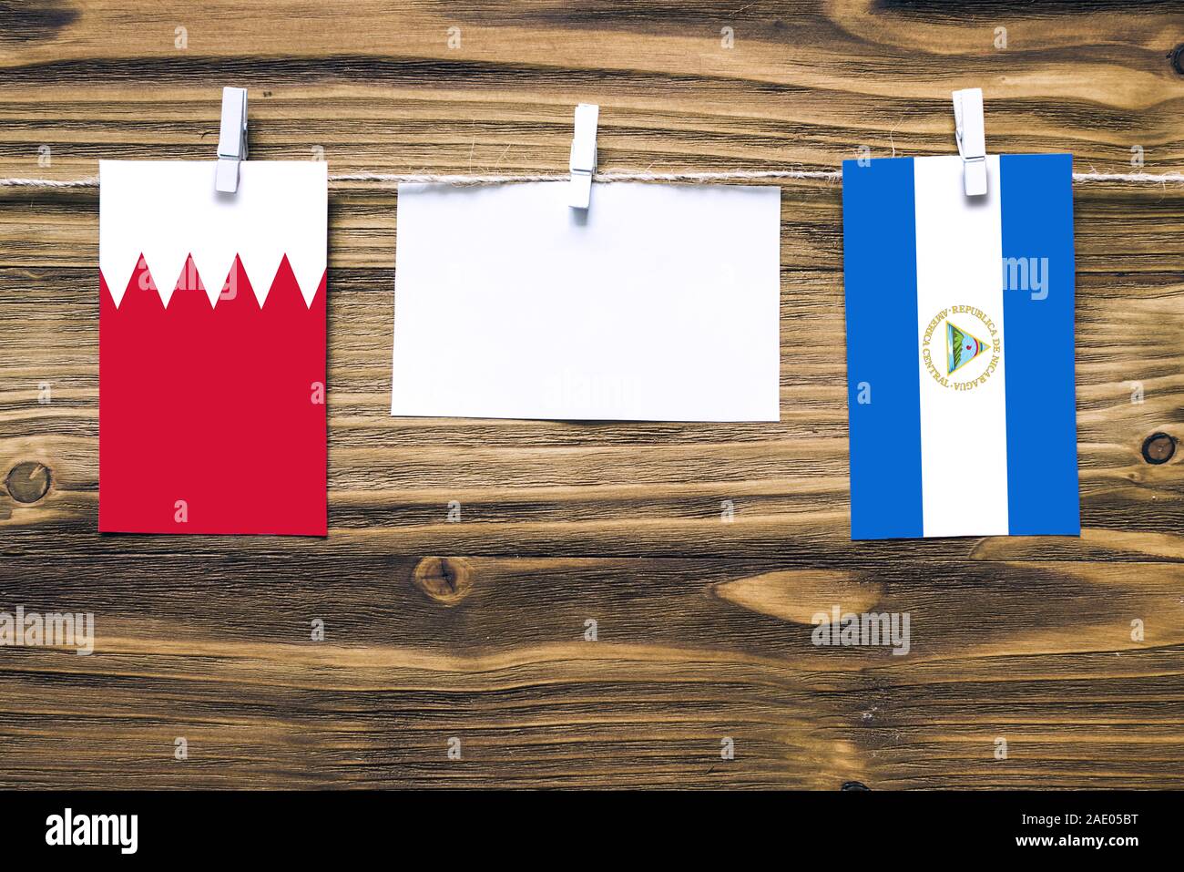 Hanging flags of Bahrain and Nicaragua attached to rope with clothes ...