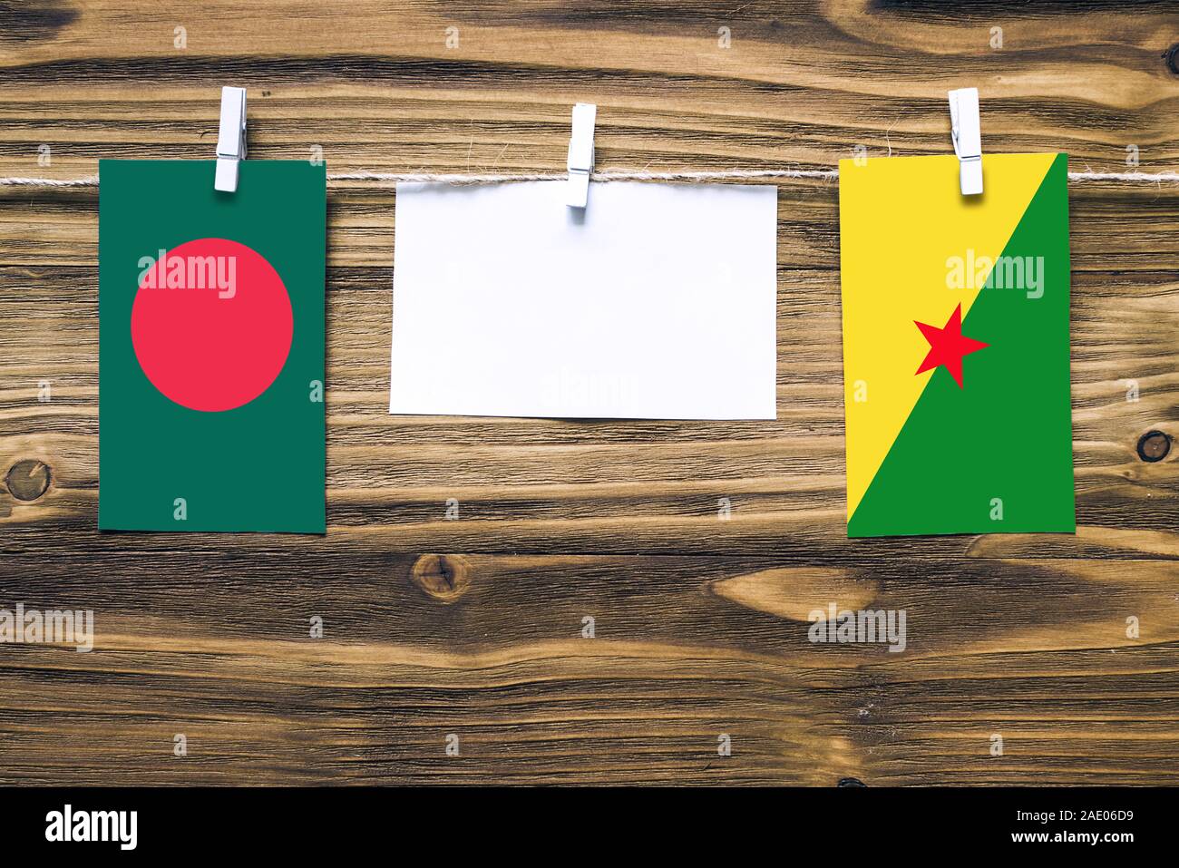 Hanging flags of Bangladesh and French Guiana attached to rope with ...