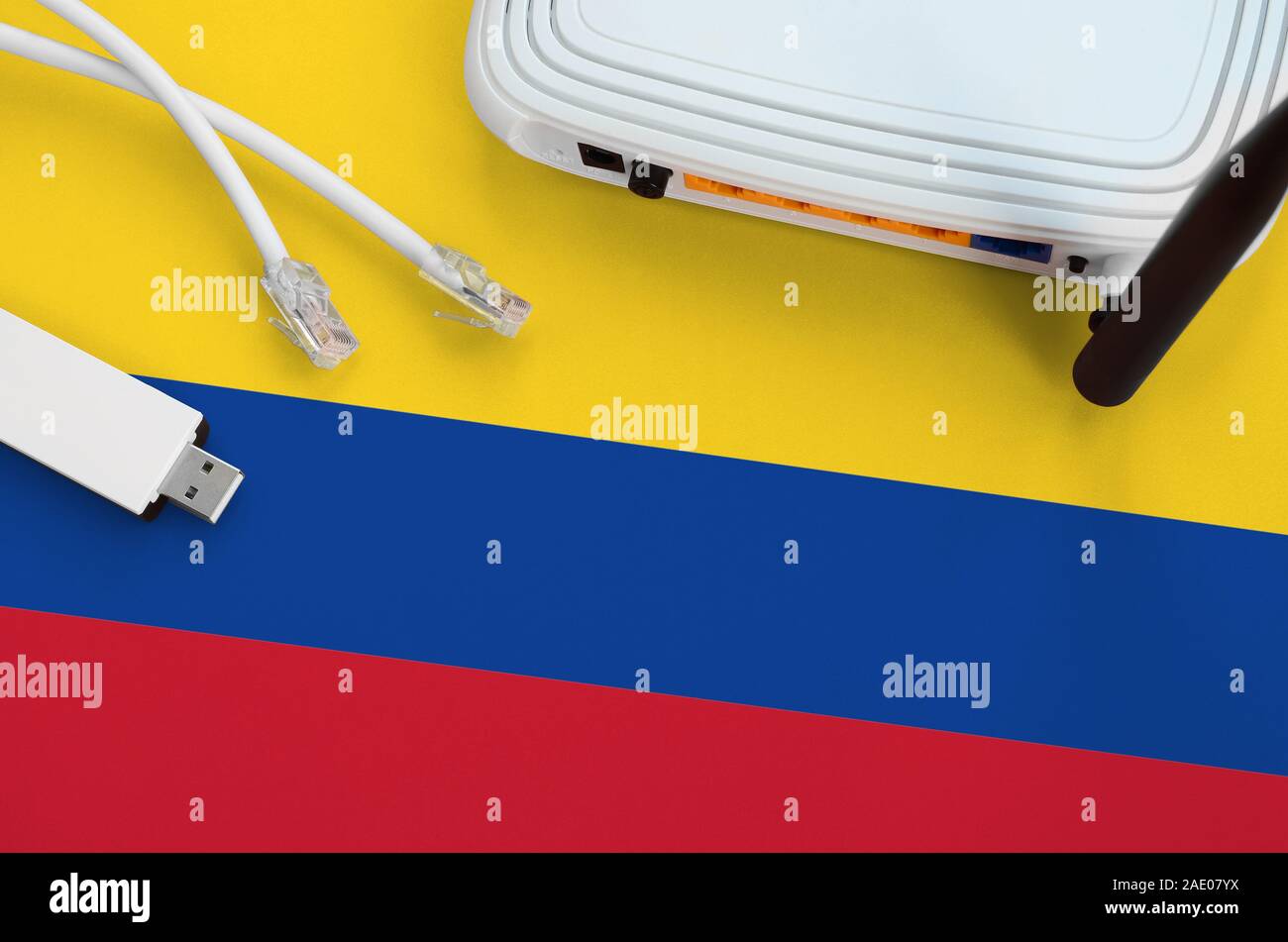 Colombia flag depicted on table with internet rj45 cable, wireless usb ...