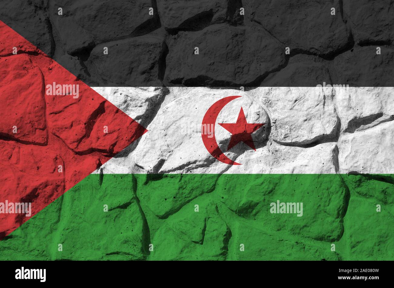 Western Sahara flag depicted in paint colors on old stone wall close up ...