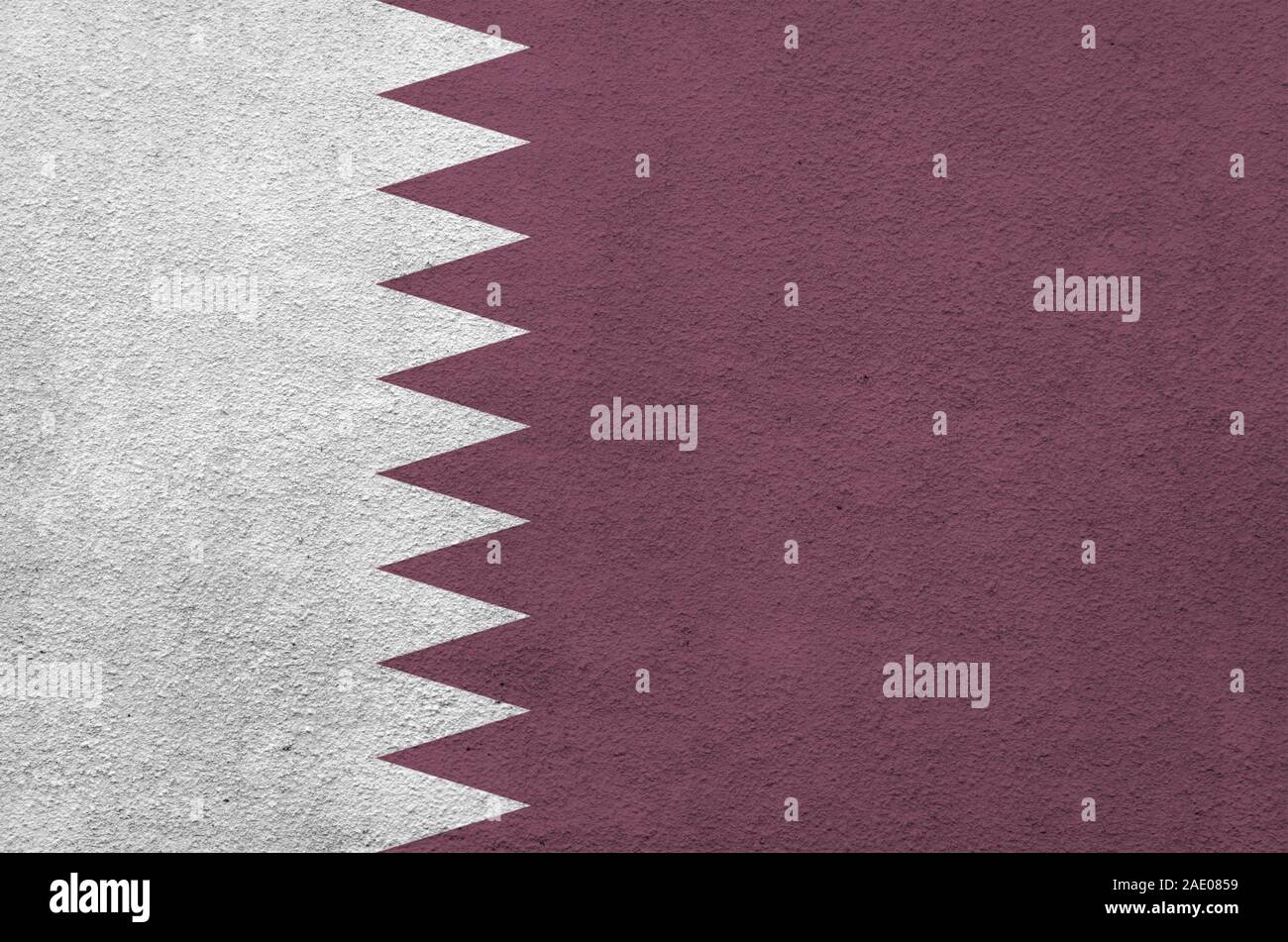 Qatar flag depicted in bright paint colors on old relief plastering ...