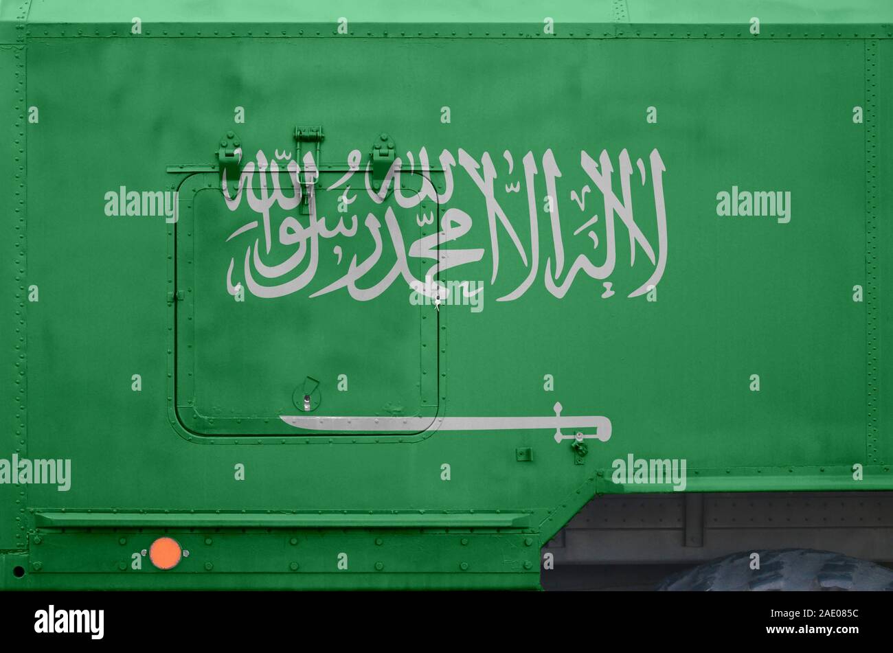 Saudi Arabia flag depicted on side part of military armored truck close ...