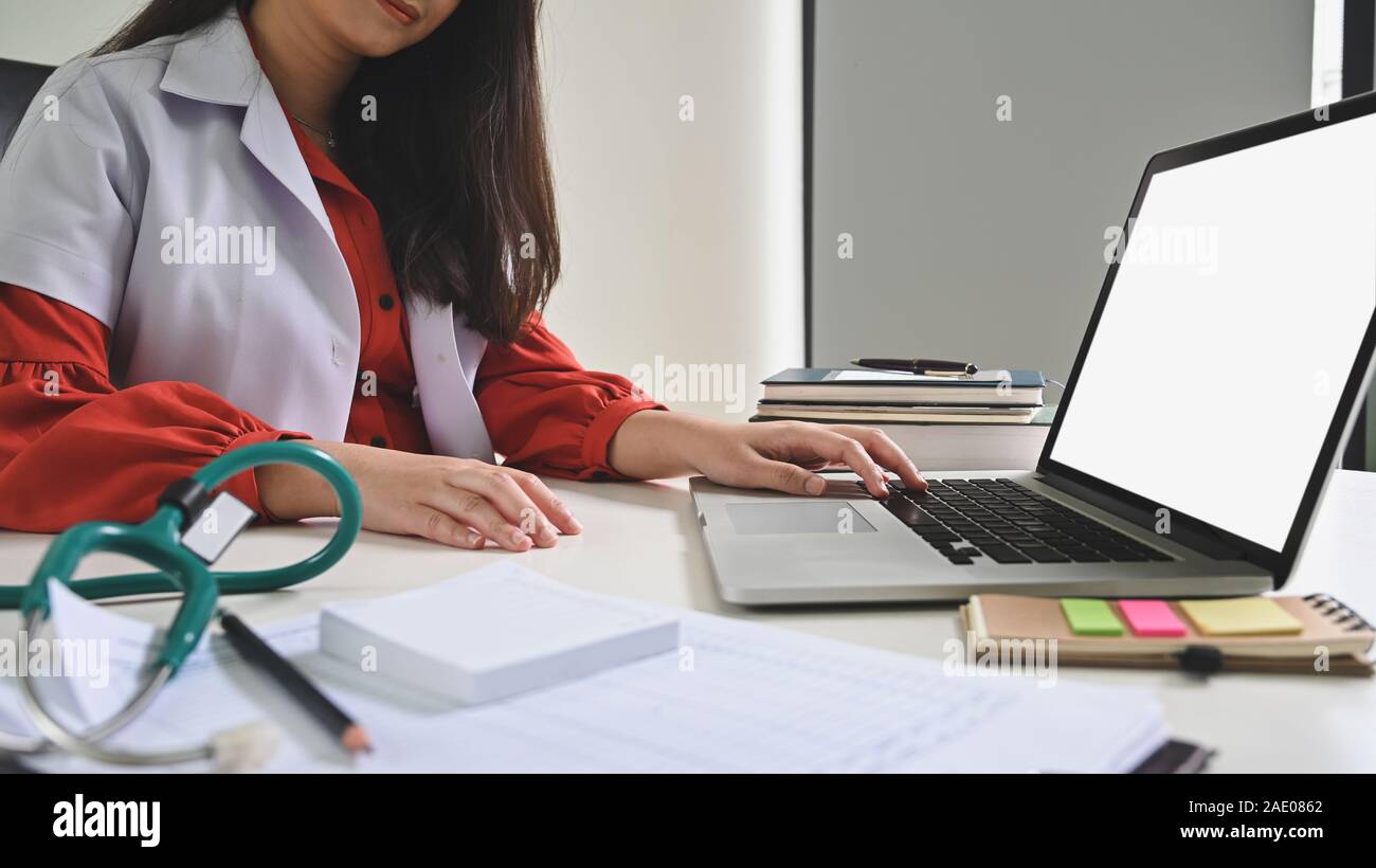 Female doctor using laptop with empty screen computer Stock Photo - Alamy