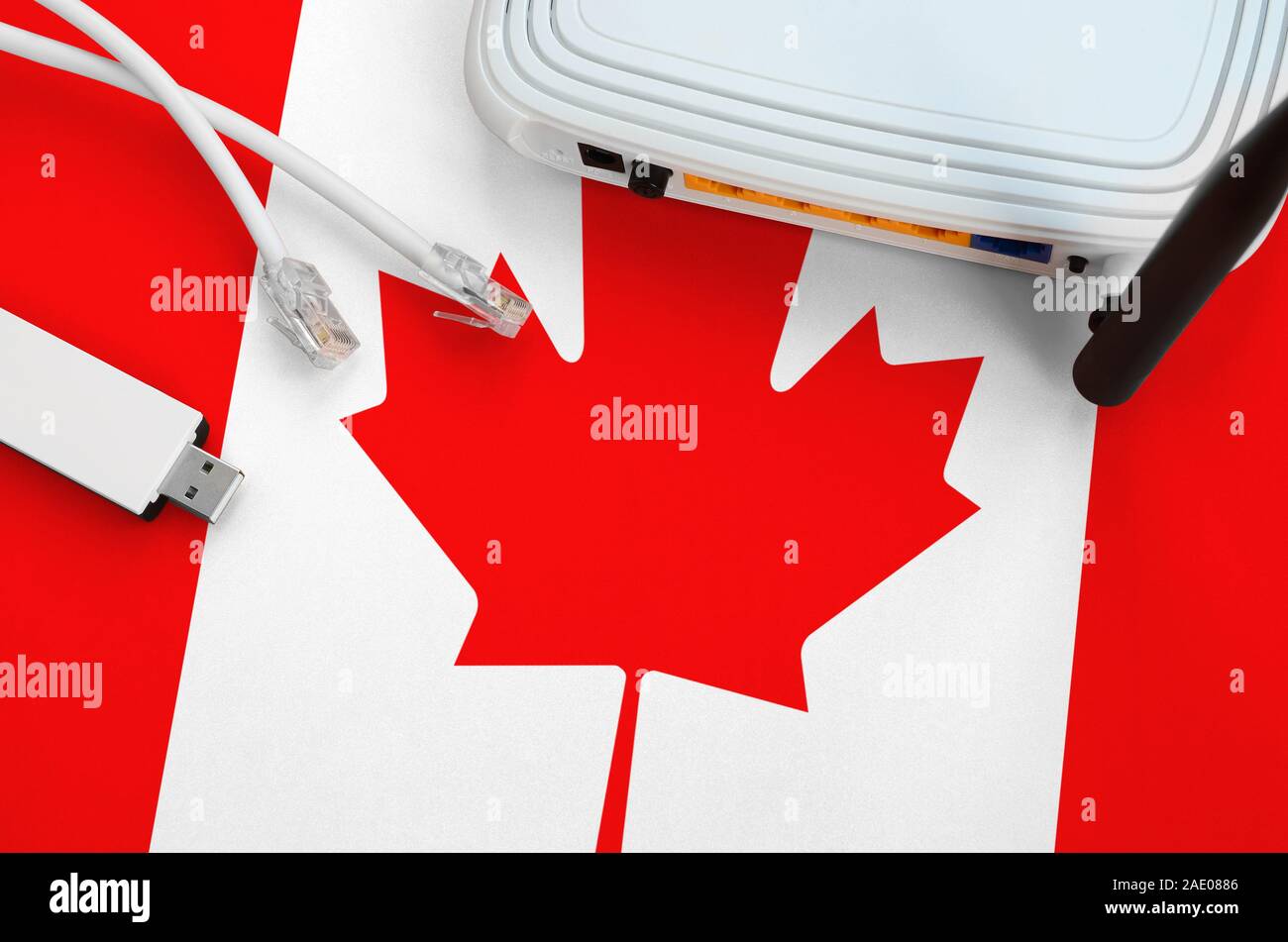 Canada flag depicted on table with internet rj45 cable, wireless usb wi ...