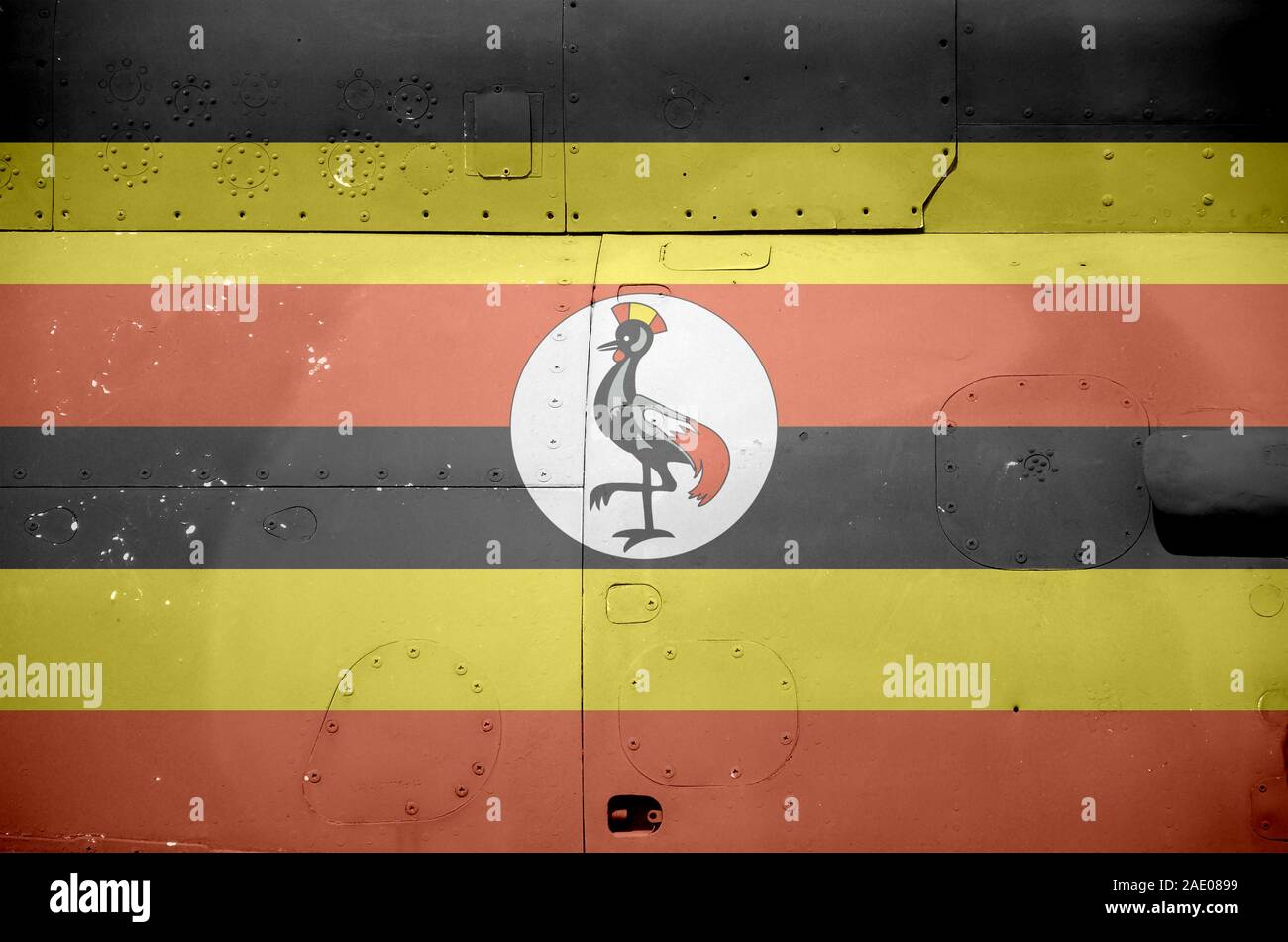 Uganda flag depicted on side part of military armored helicopter close ...