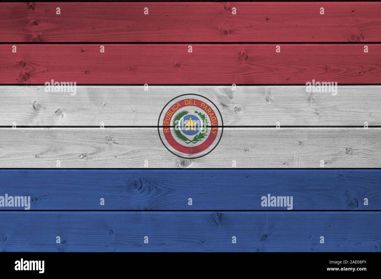 Paraguay flag depicted in bright paint colors on old wooden wall close ...