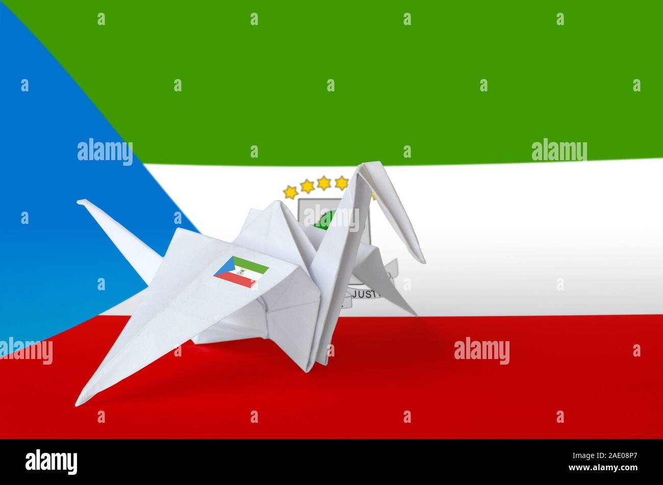 Equatorial Guinea flag depicted on paper origami crane wing. Oriental ...