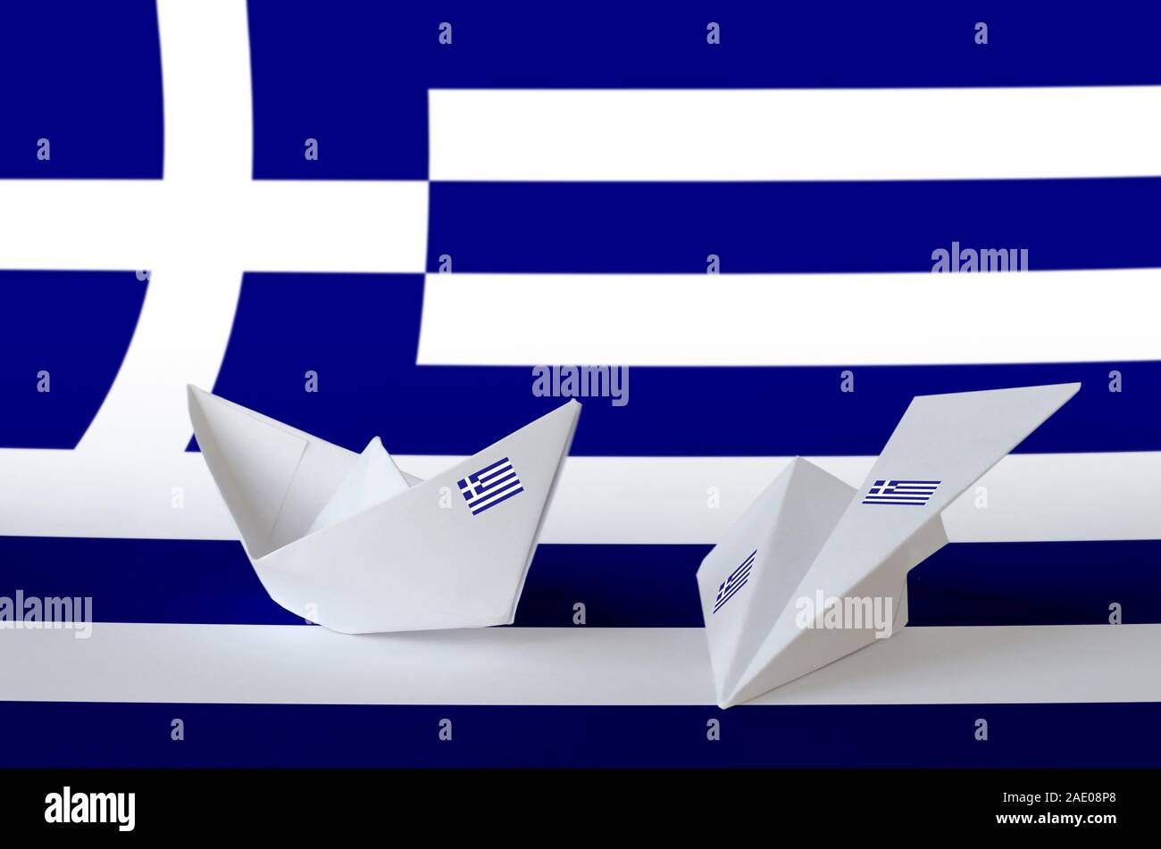 Greece flag depicted on paper origami airplane and boat. Oriental ...