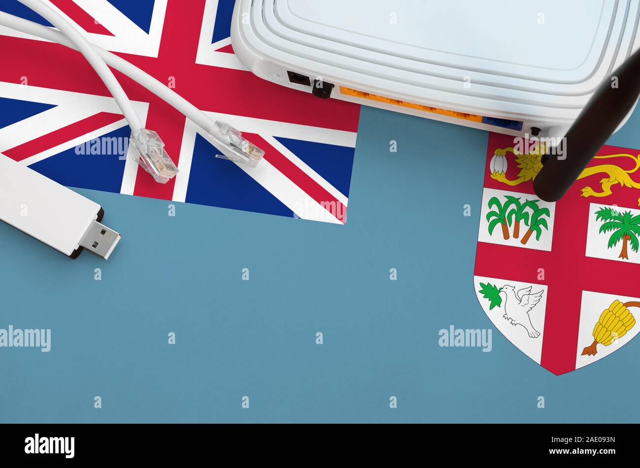 Fiji flag depicted on table with internet rj45 cable, wireless usb wi ...