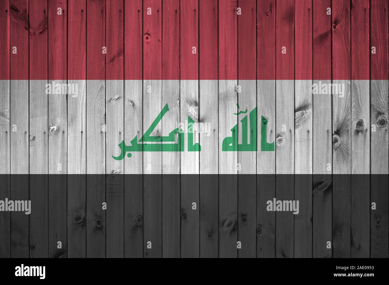 Iraq flag depicted in bright paint colors on old wooden wall close up ...