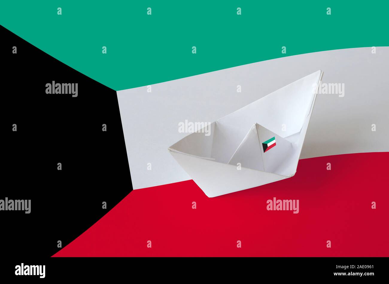 Kuwait flag depicted on paper origami ship closeup. Oriental handmade ...