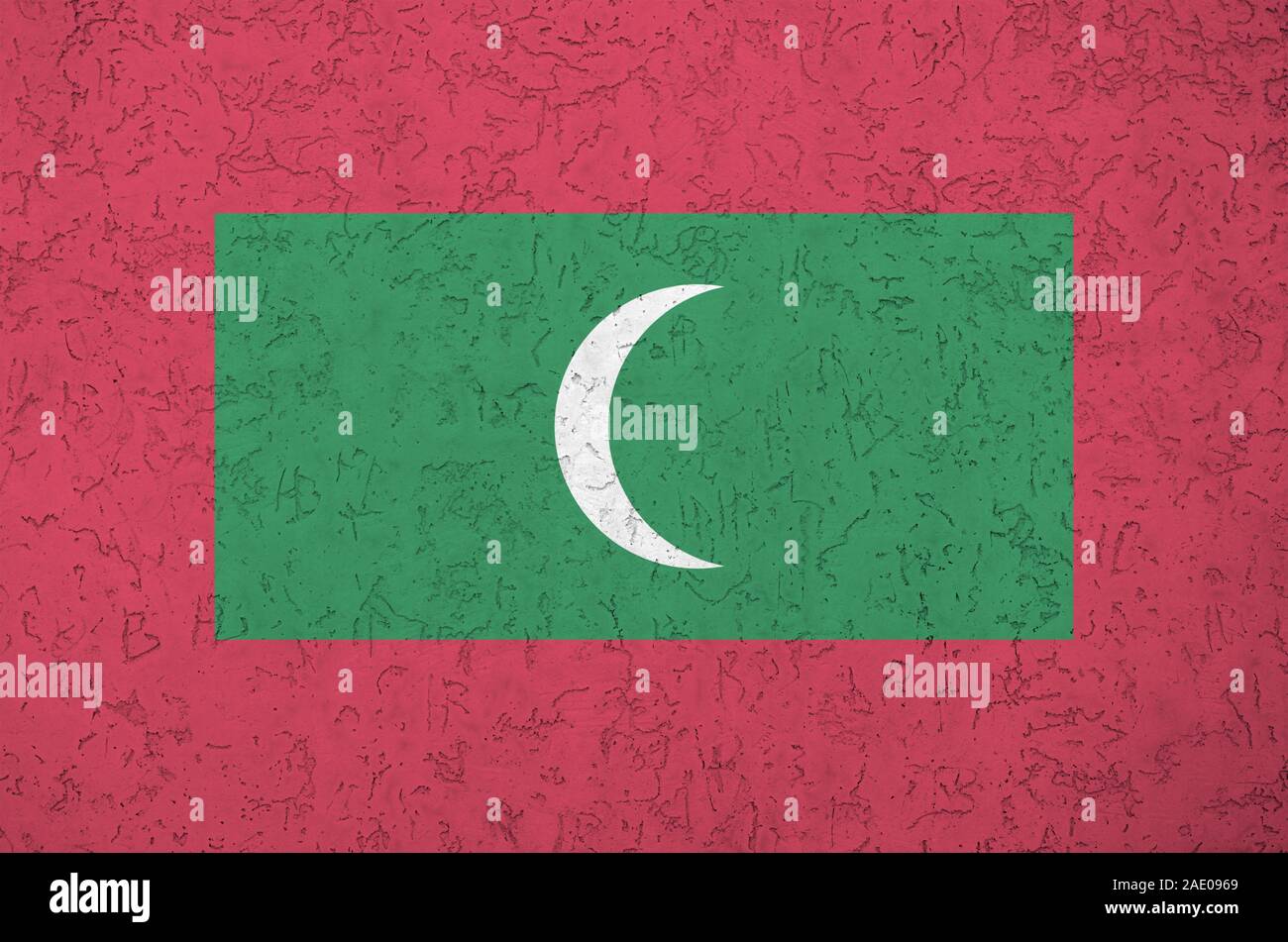 Maldives flag depicted in bright paint colors on old relief plastering ...