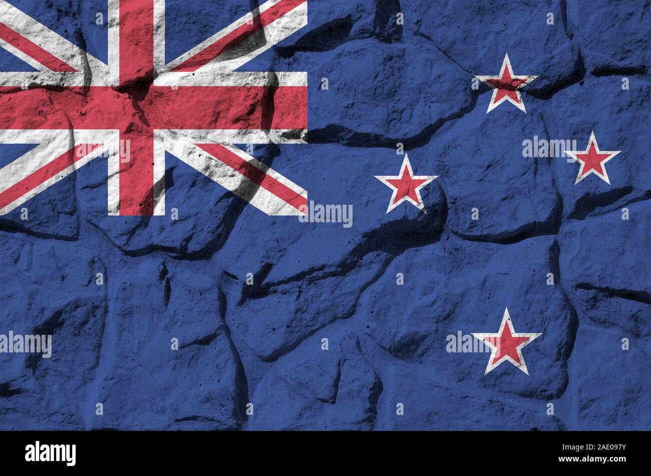 New Zealand flag depicted in paint colors on old stone wall close up ...