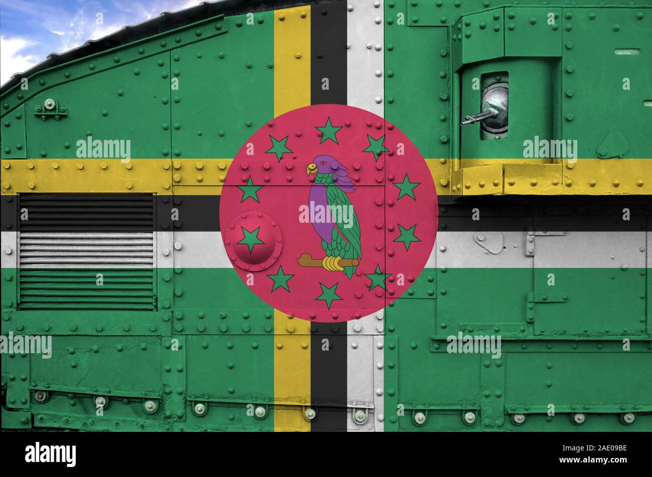 Dominica flag depicted on side part of military armored tank close up ...