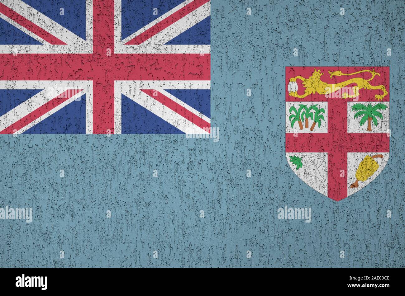Fiji flag depicted in bright paint colors on old relief plastering wall ...