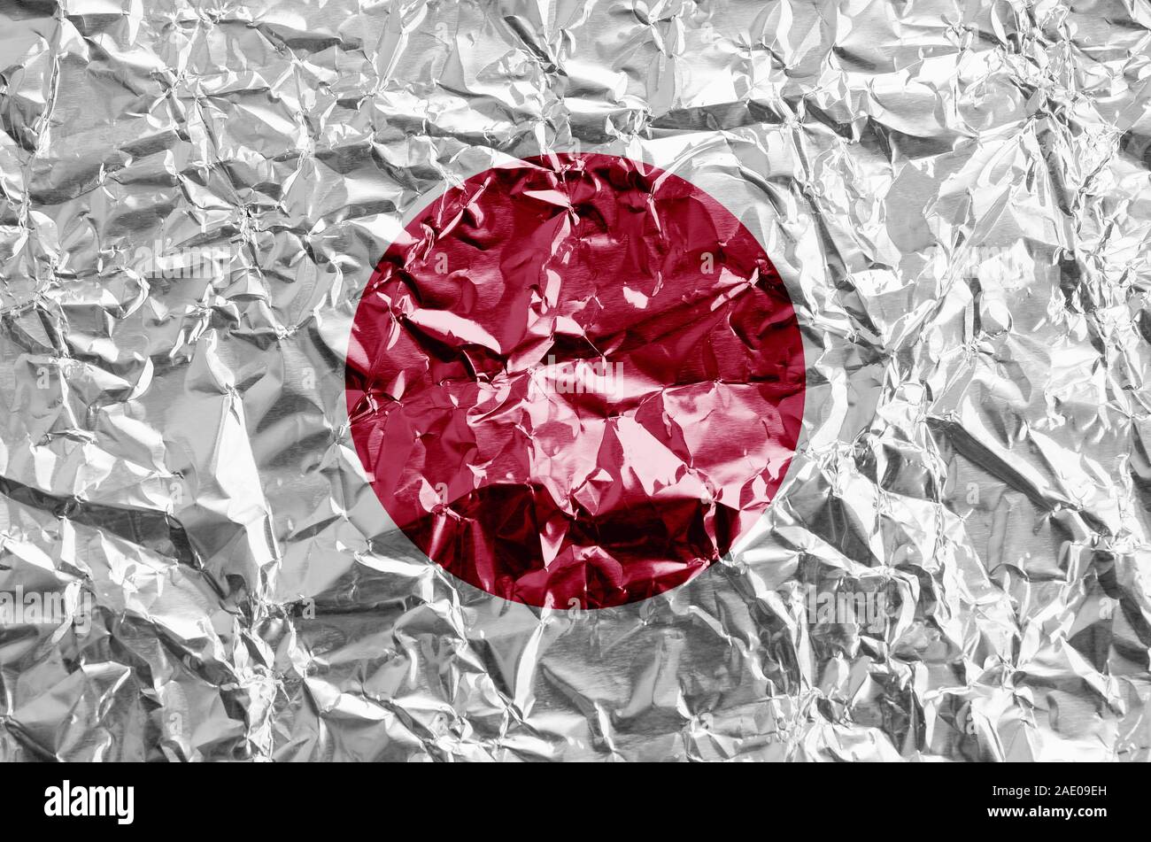 Japan flag depicted in paint colors on shiny crumpled aluminium foil ...