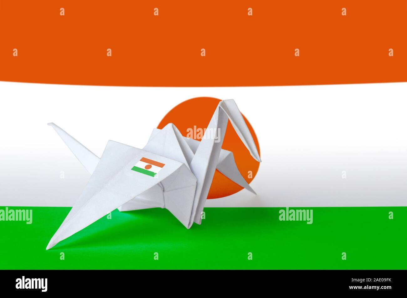 Niger flag depicted on paper origami crane wing. Oriental handmade arts ...