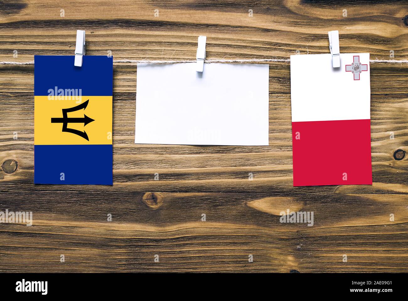 Hanging flags of Barbados and Malta attached to rope with clothes pins ...