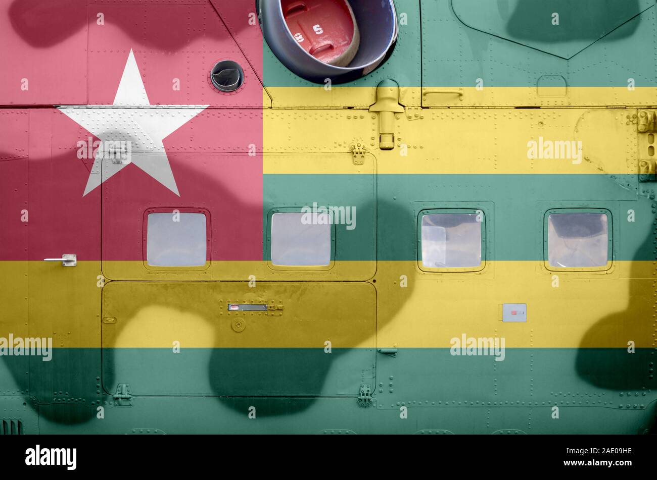 Togo flag depicted on side part of military armored helicopter close up ...