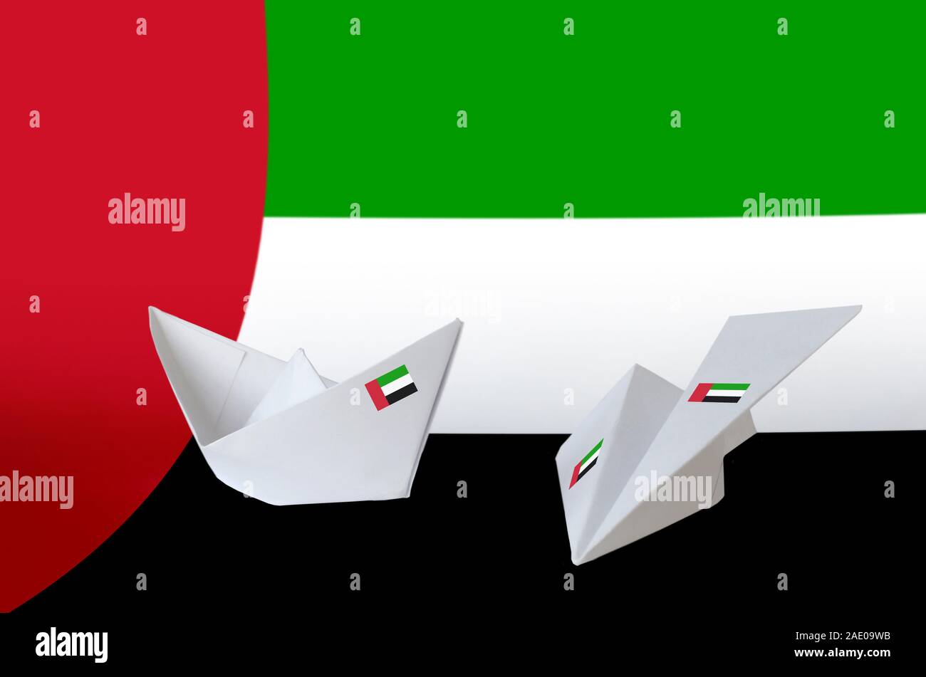 United Arab Emirates flag depicted on paper origami airplane and boat ...