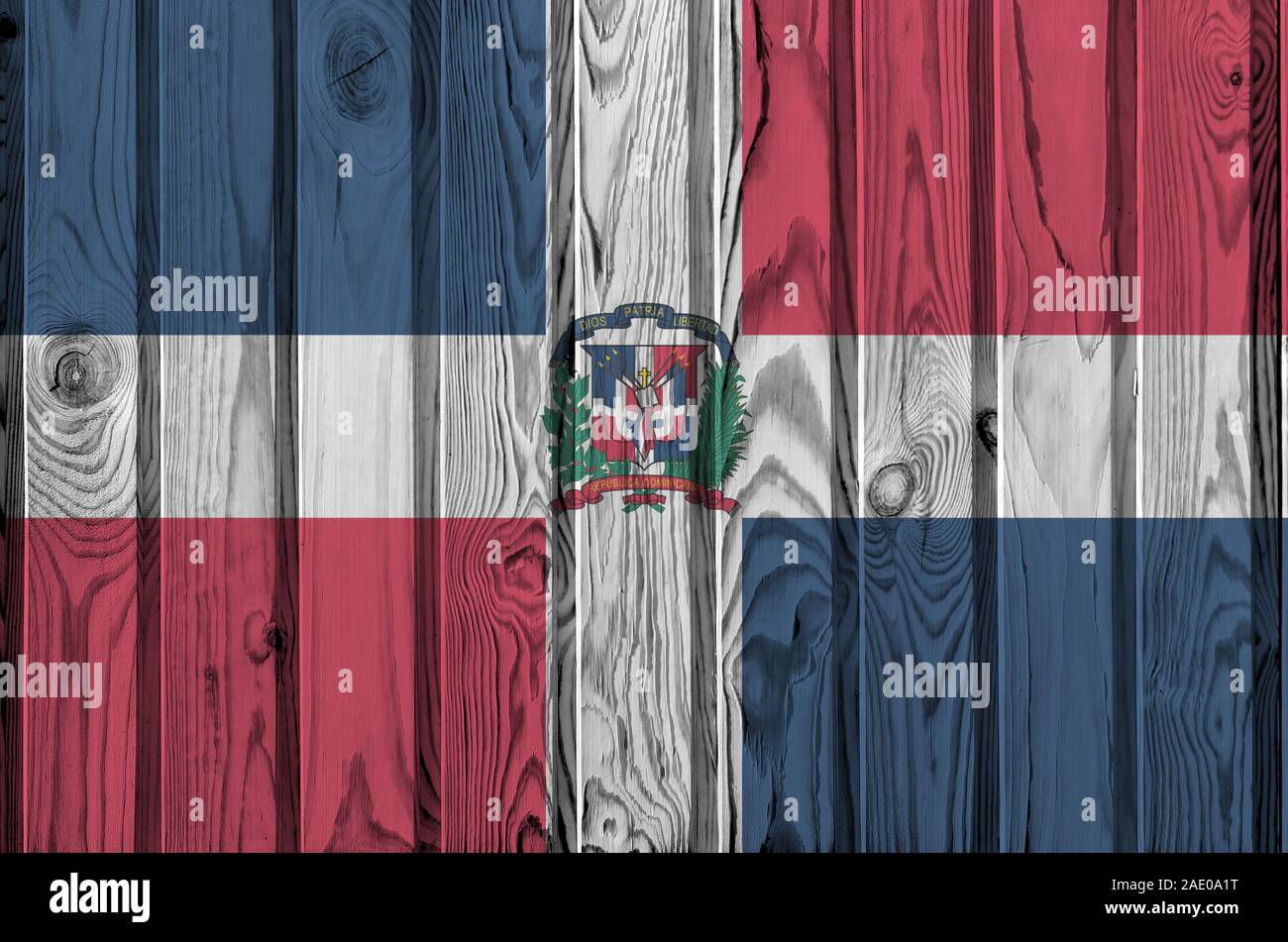 Dominican Republic flag depicted in bright paint colors on old wooden ...