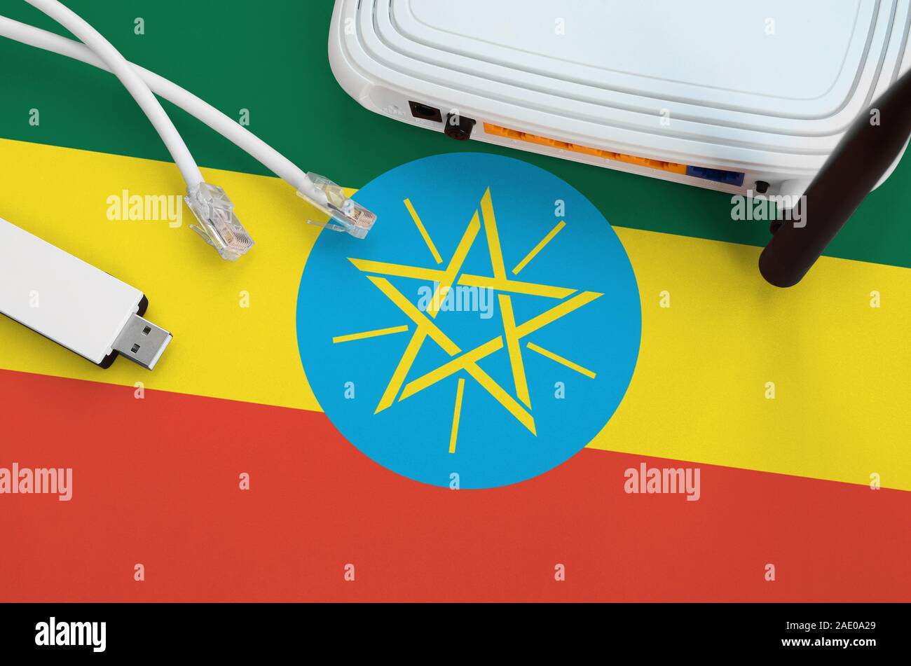 Ethiopia flag depicted on table with internet rj45 cable, wireless usb ...
