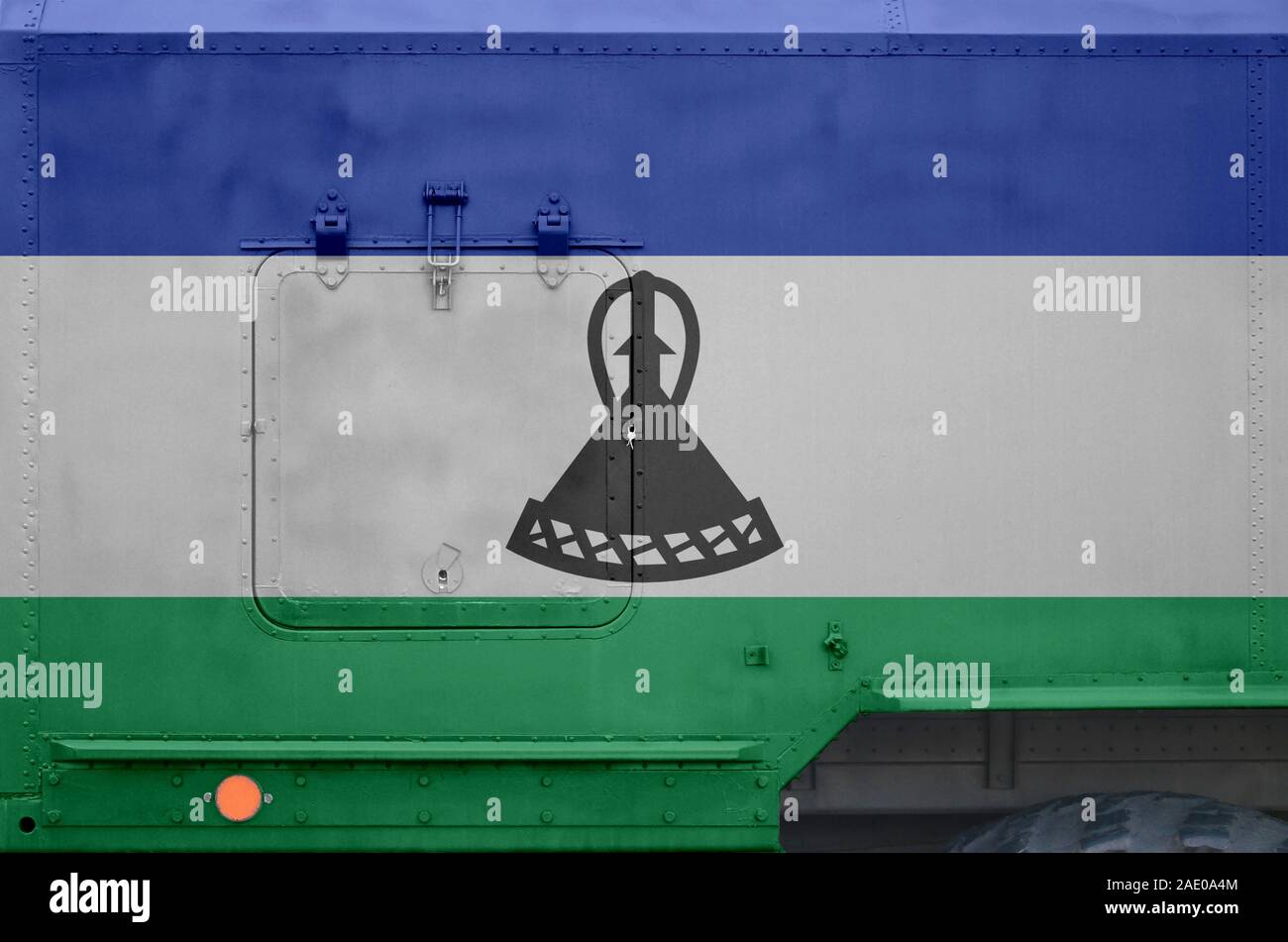Lesotho flag depicted on side part of military armored truck close up ...