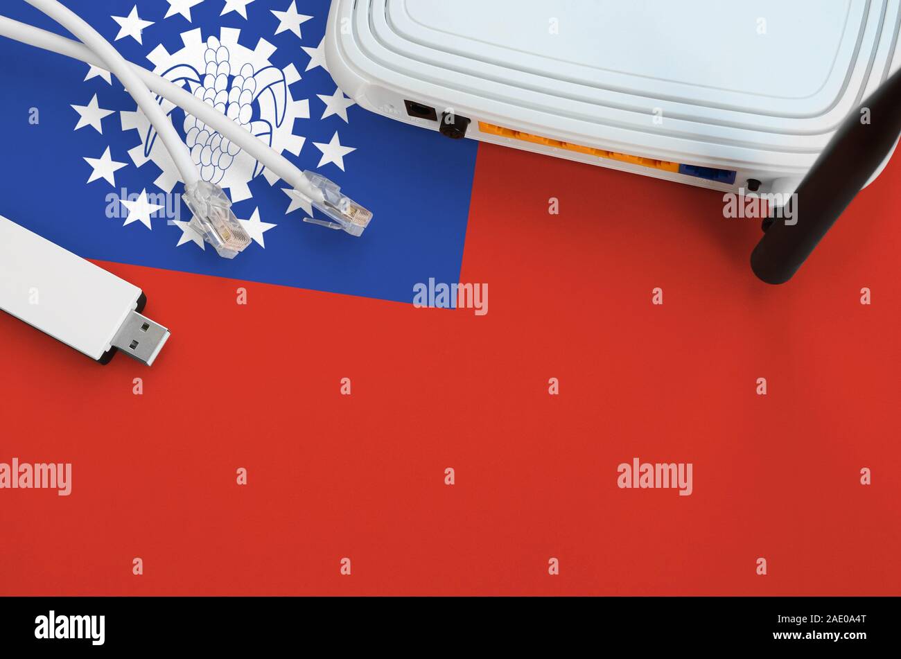 Myanmar flag depicted on table with internet rj45 cable, wireless usb ...