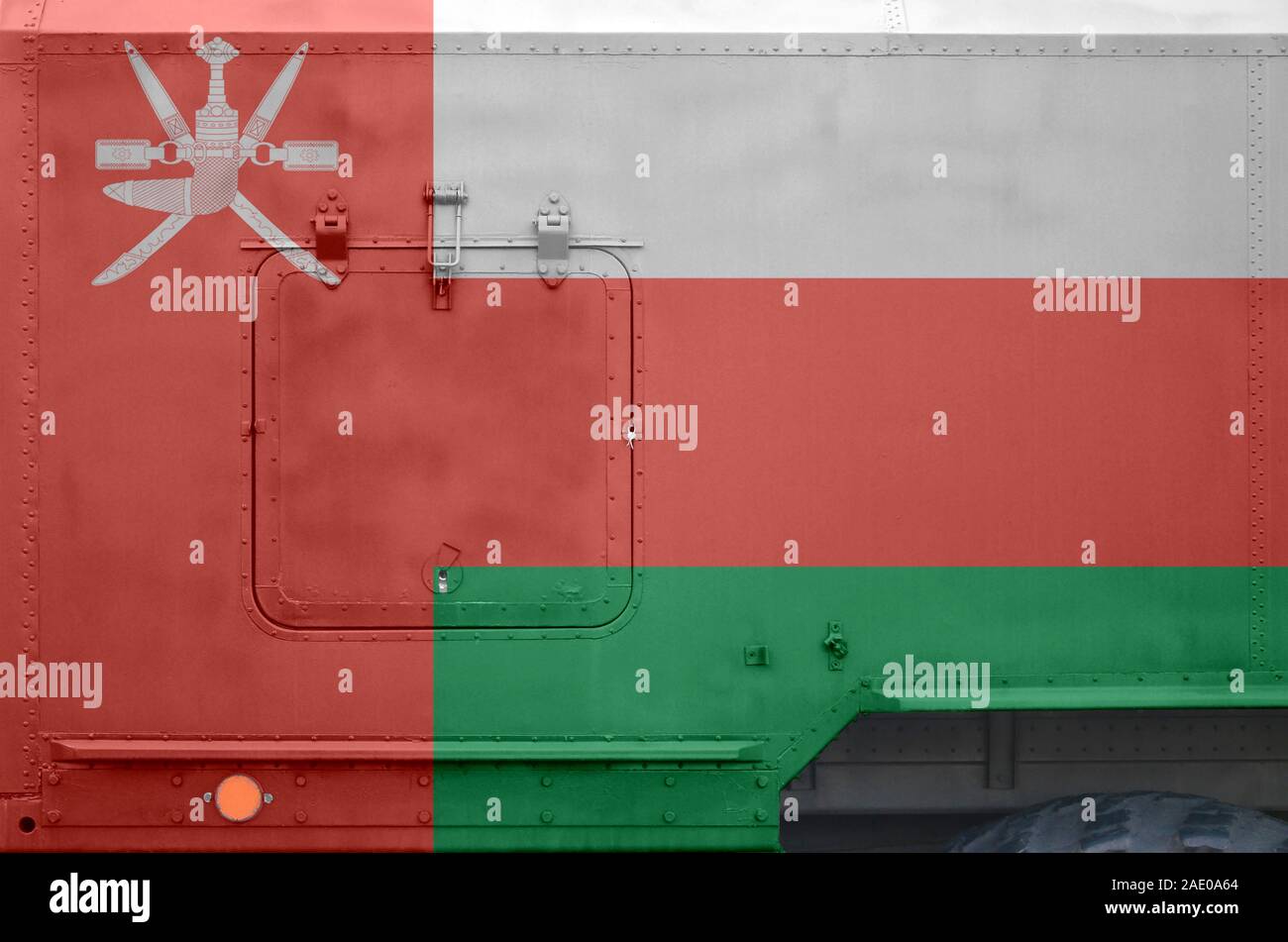 Oman flag depicted on side part of military armored truck close up ...