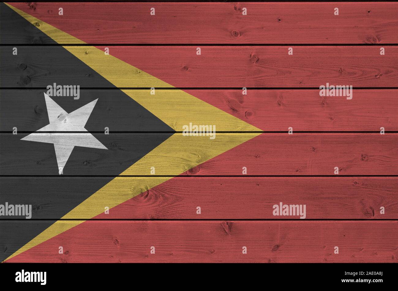 Timor Leste flag depicted in bright paint colors on old wooden wall ...
