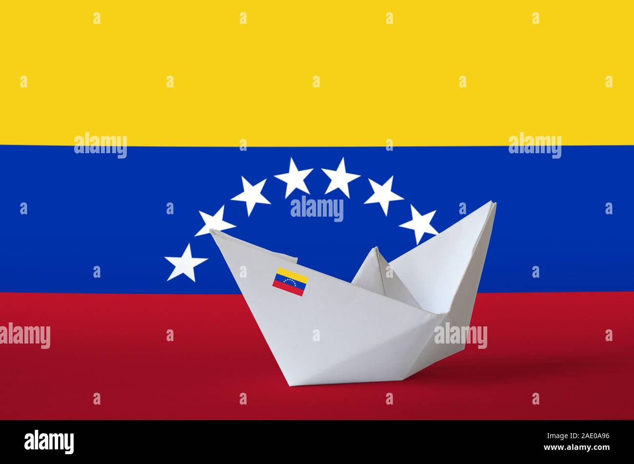 Venezuela flag depicted on paper origami ship closeup. Oriental ...