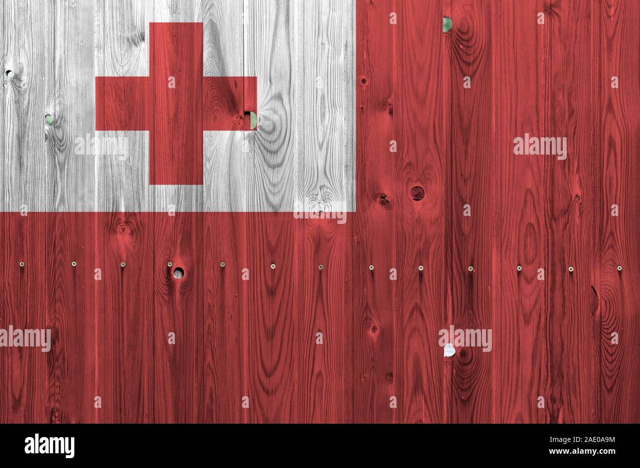Tonga flag depicted in bright paint colors on old wooden wall close up ...