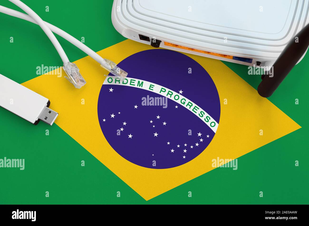 Brazil flag depicted on table with internet rj45 cable, wireless usb wi ...