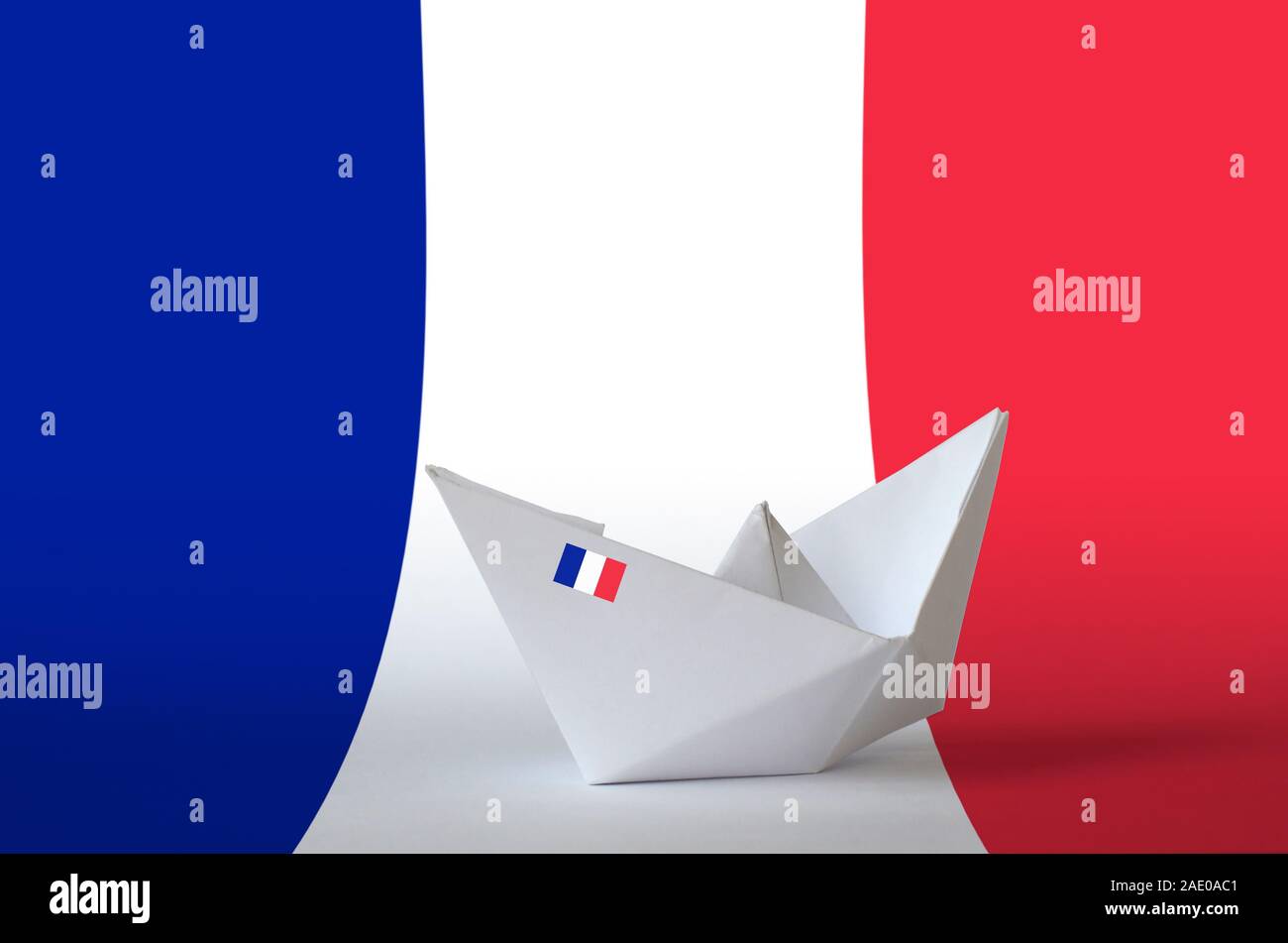 France flag depicted on paper origami ship closeup. Oriental handmade ...