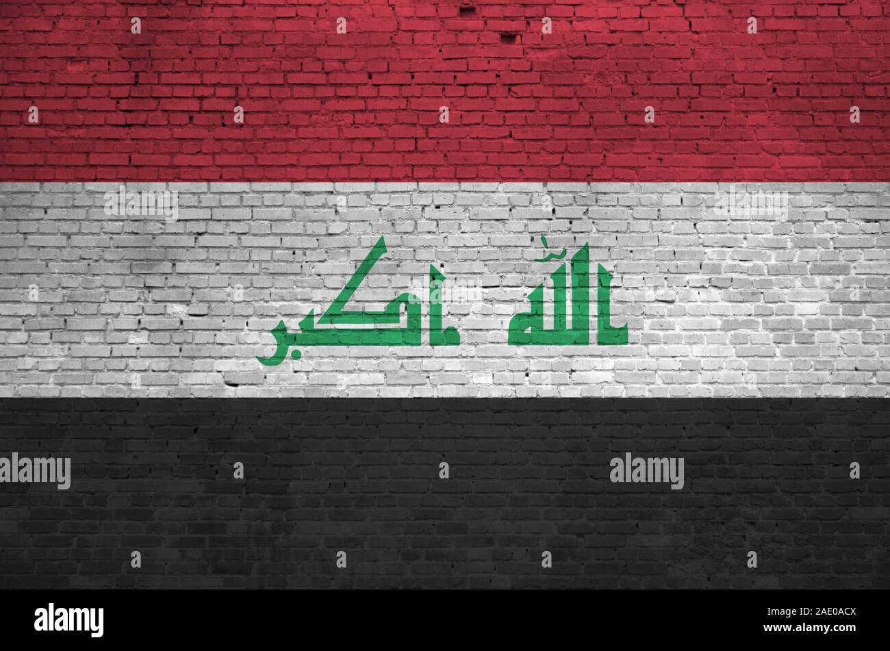 Iraq flag depicted in paint colors on old brick wall close up. Textured ...