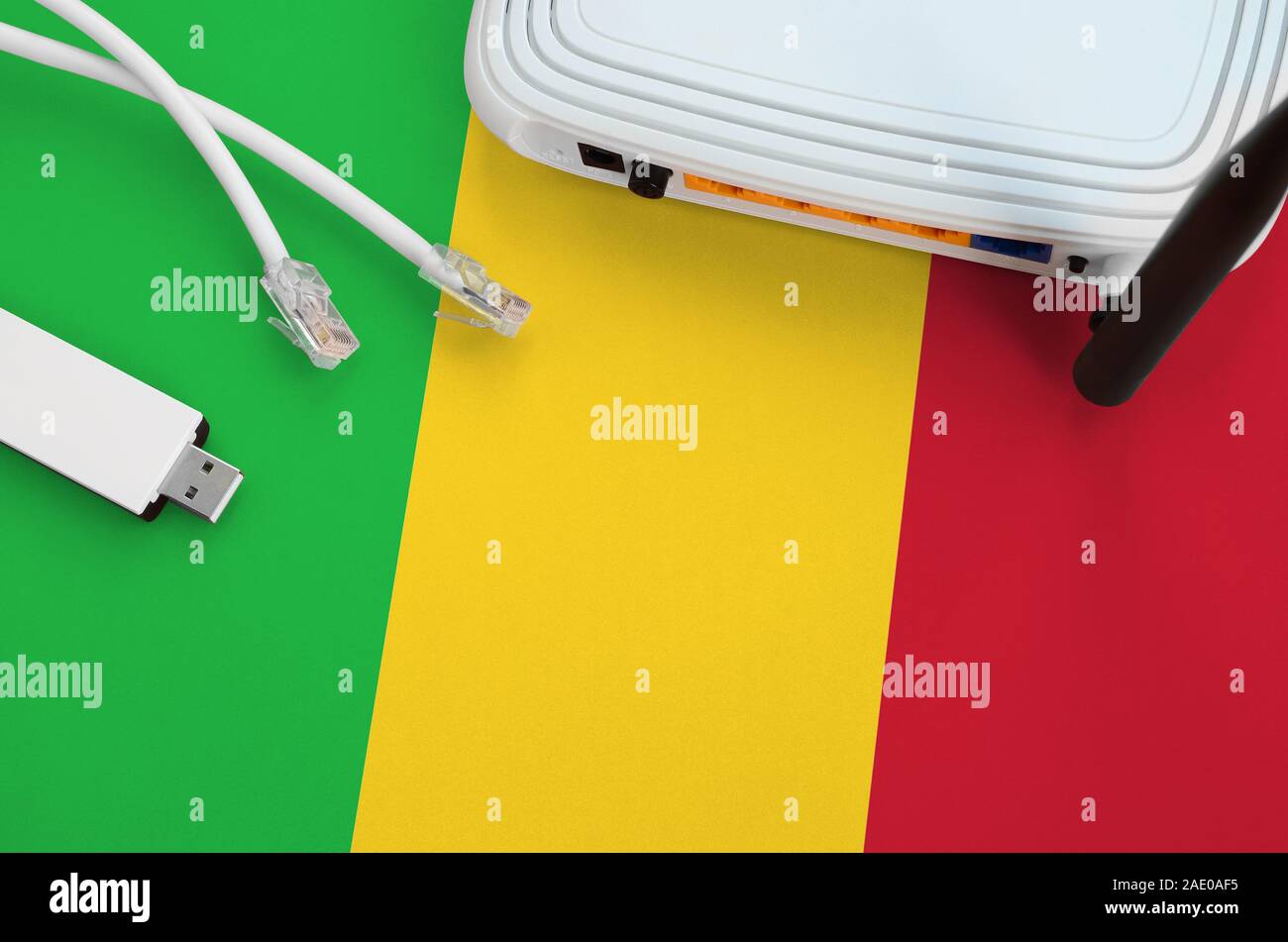 Mali flag depicted on table with internet rj45 cable, wireless usb wi ...