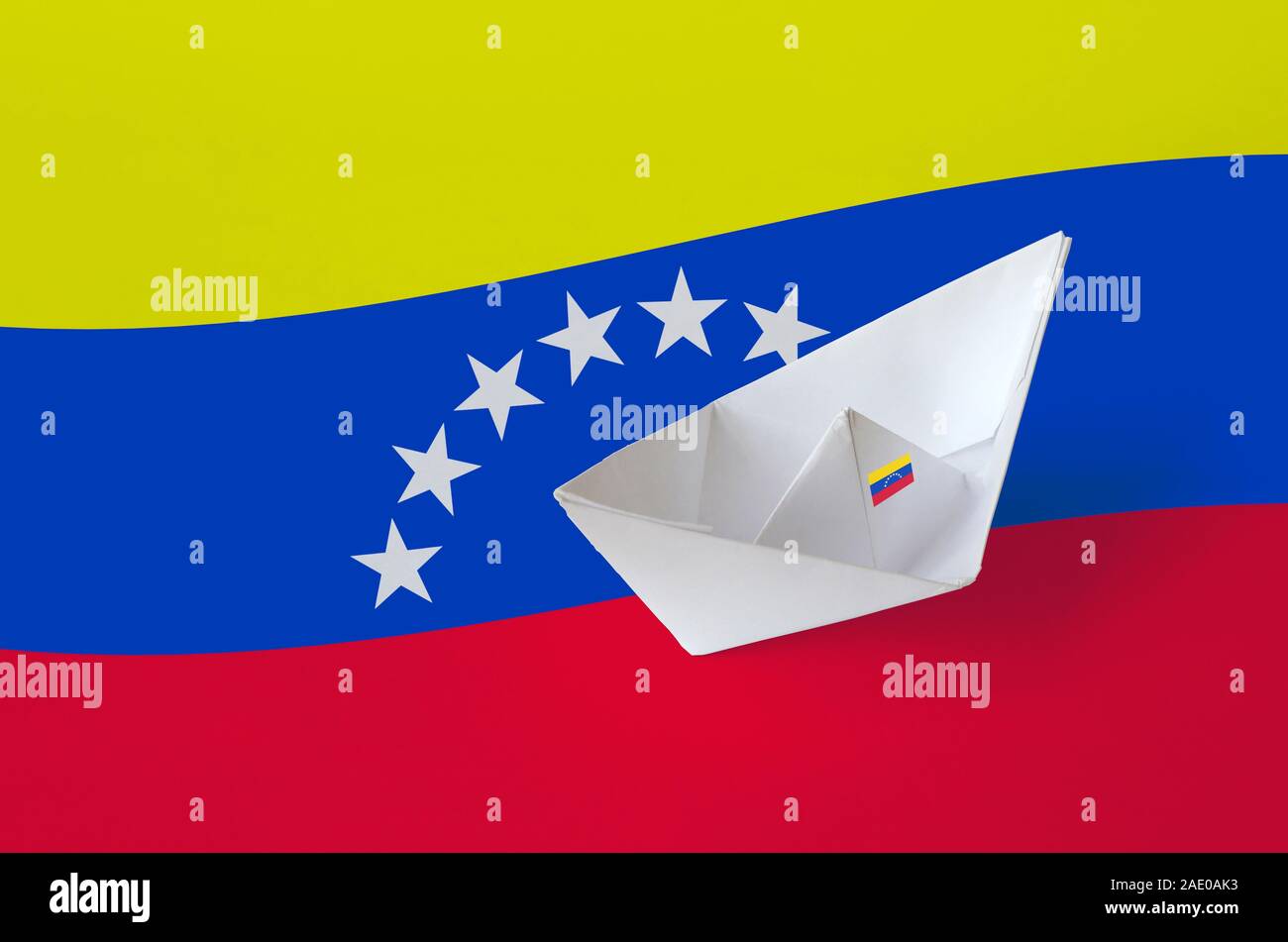 Venezuela flag depicted on paper origami ship closeup. Oriental ...