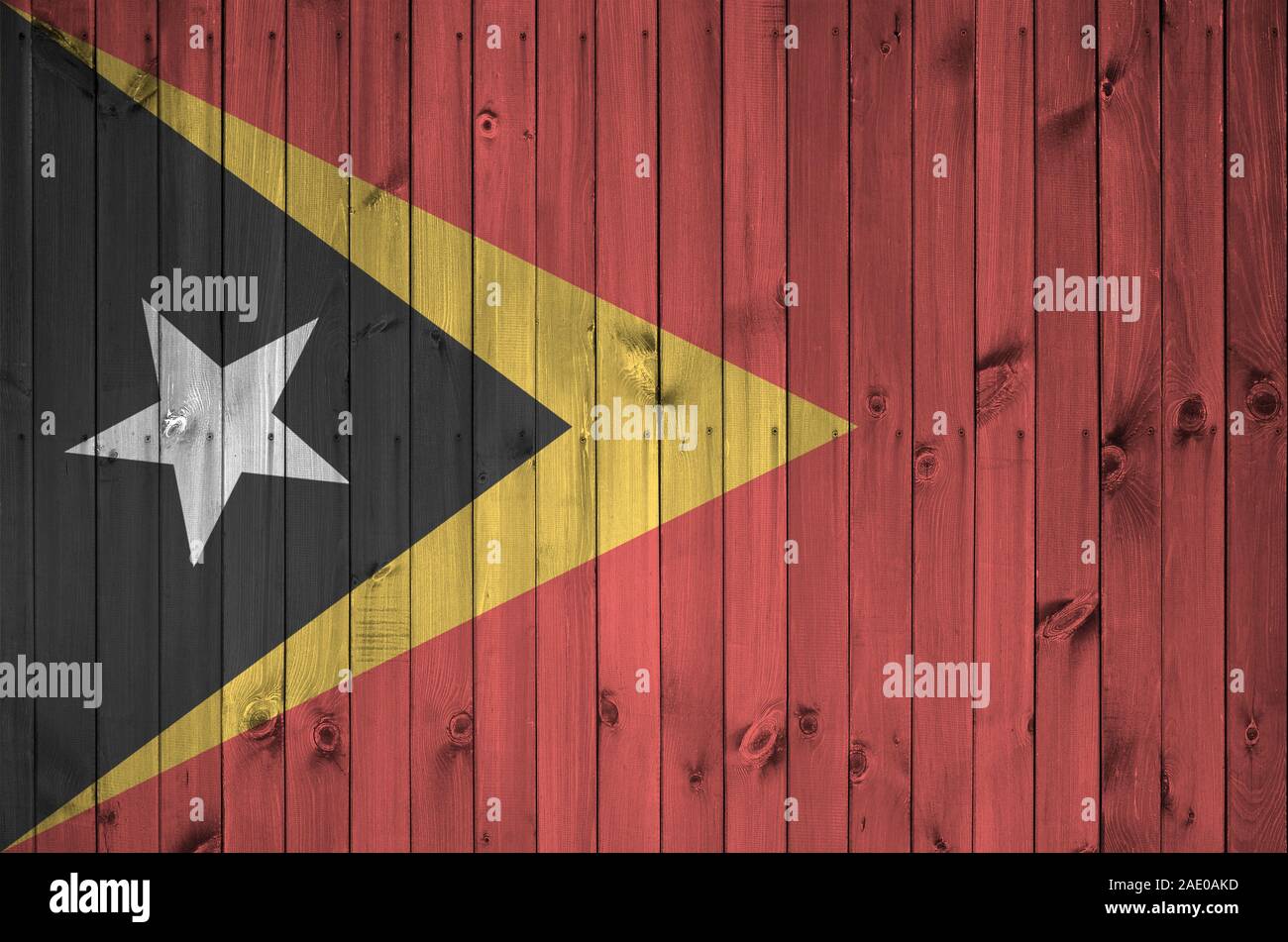 Timor Leste flag depicted in bright paint colors on old wooden wall ...