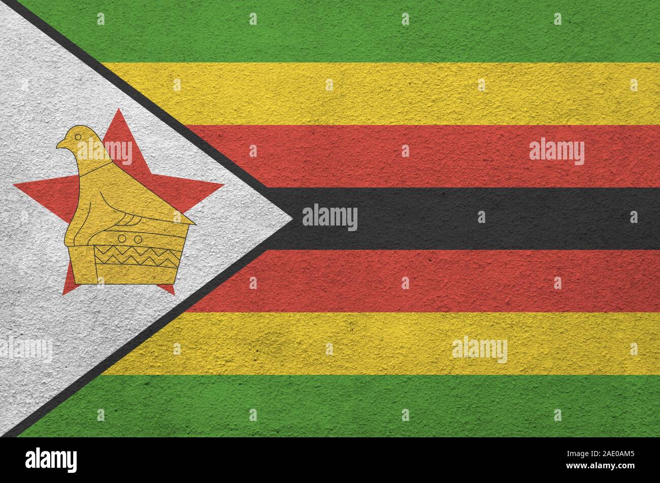 Zimbabwe flag depicted in bright paint colors on old relief plastering ...