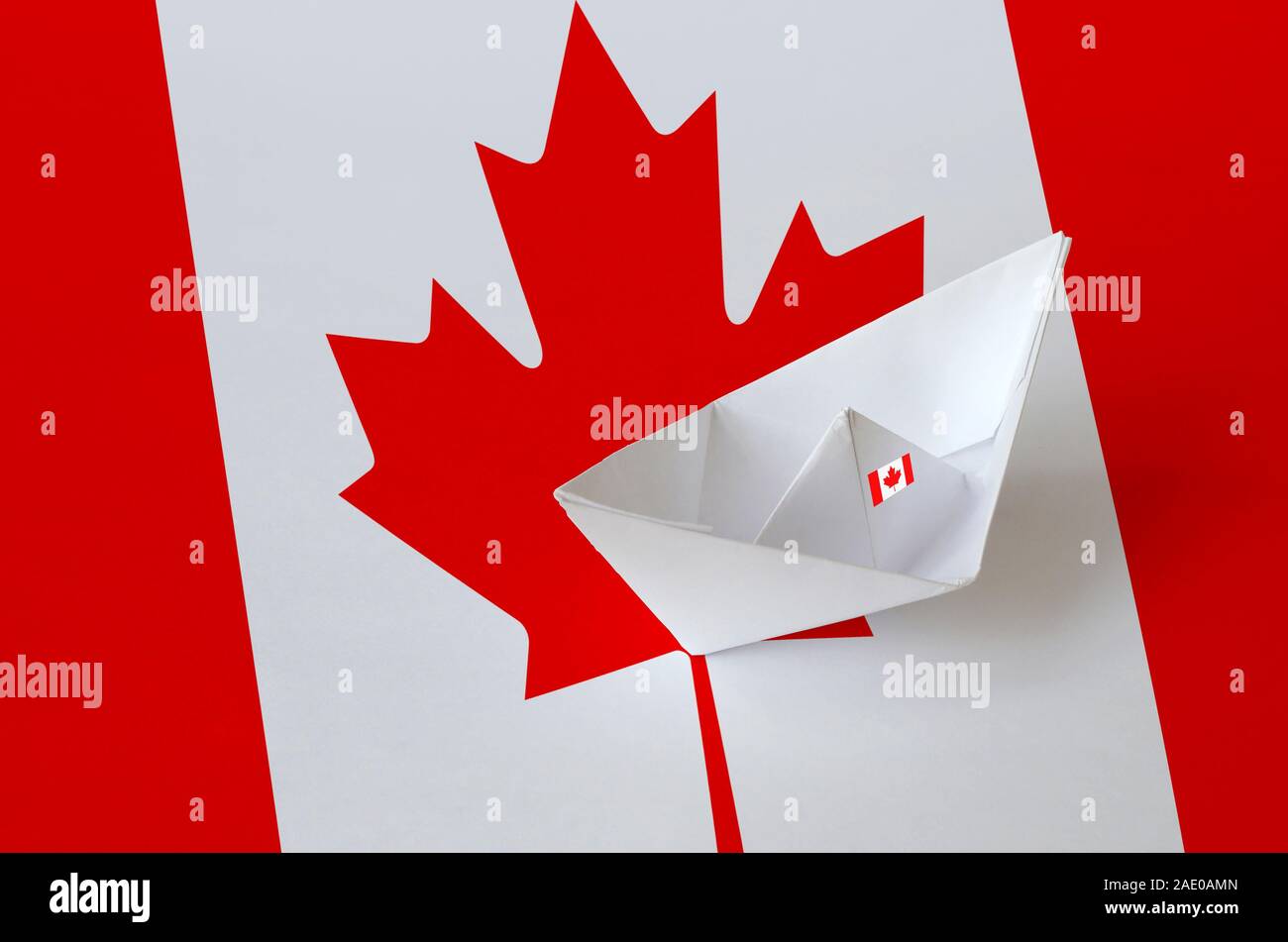 Canada flag depicted on paper origami ship closeup. Oriental handmade ...